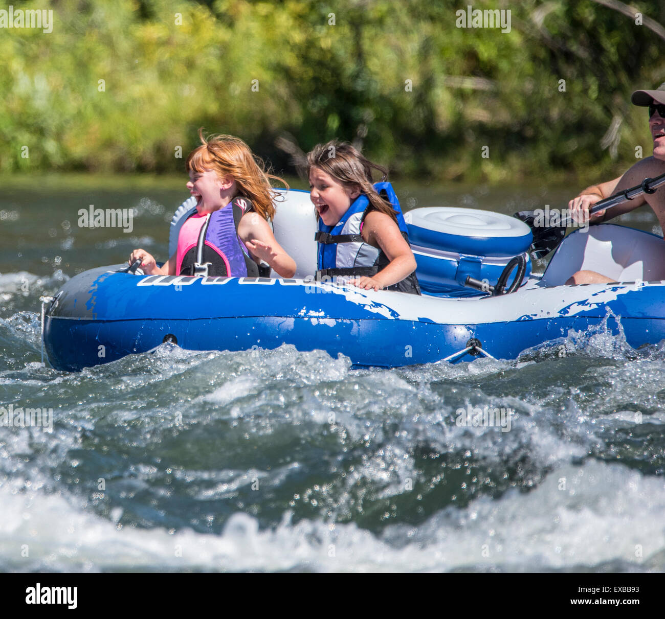 Floating the Boise river. KIds having fun going through rapids on a ...
