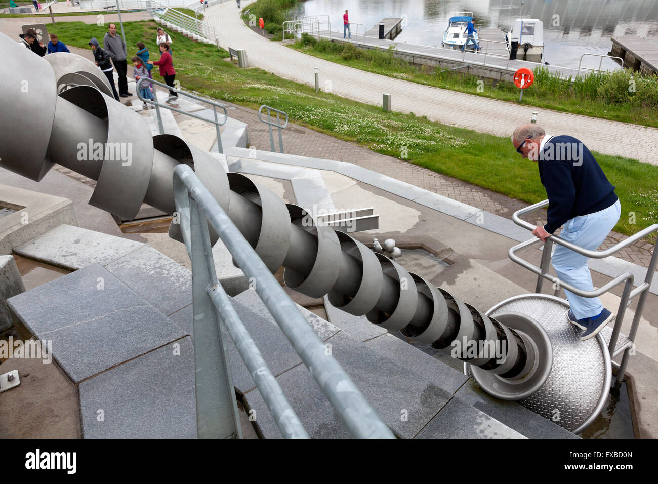 Visitor operating the Archimedes screw in the Water Play Park at the ...