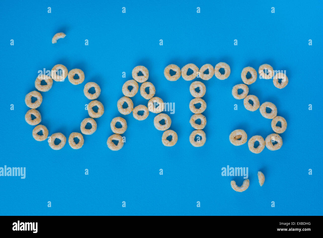 Oats spelled out using oat breakfast cereal over blue background Stock ...