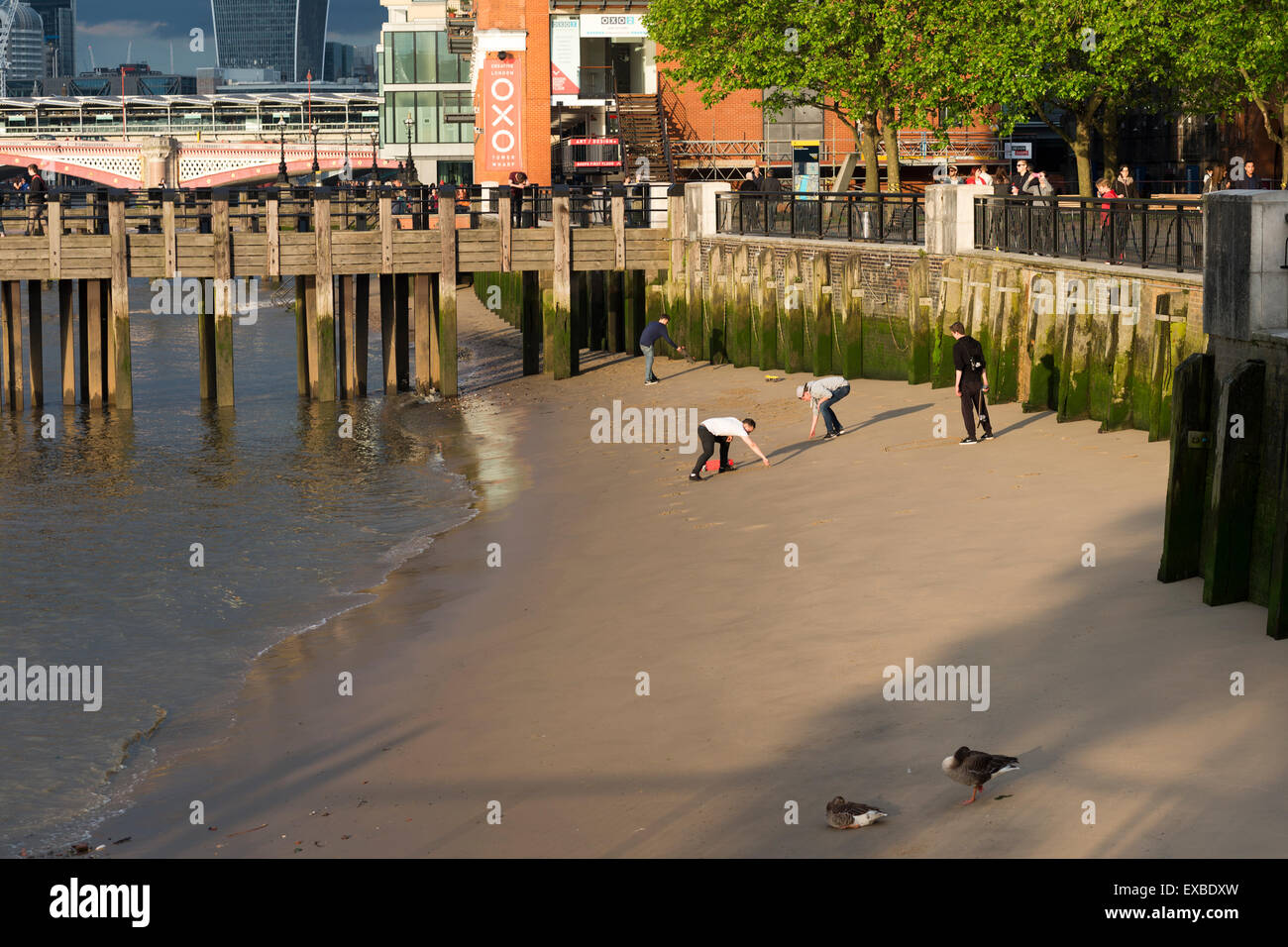 People playing on a River Thames beach near the Oxo Tower & Gabriel's ...