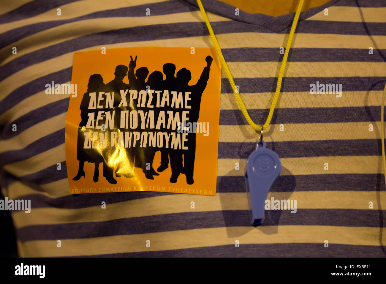 Mass sticker slogan on Tshirt stating 'We do not owe, We do not sell ...