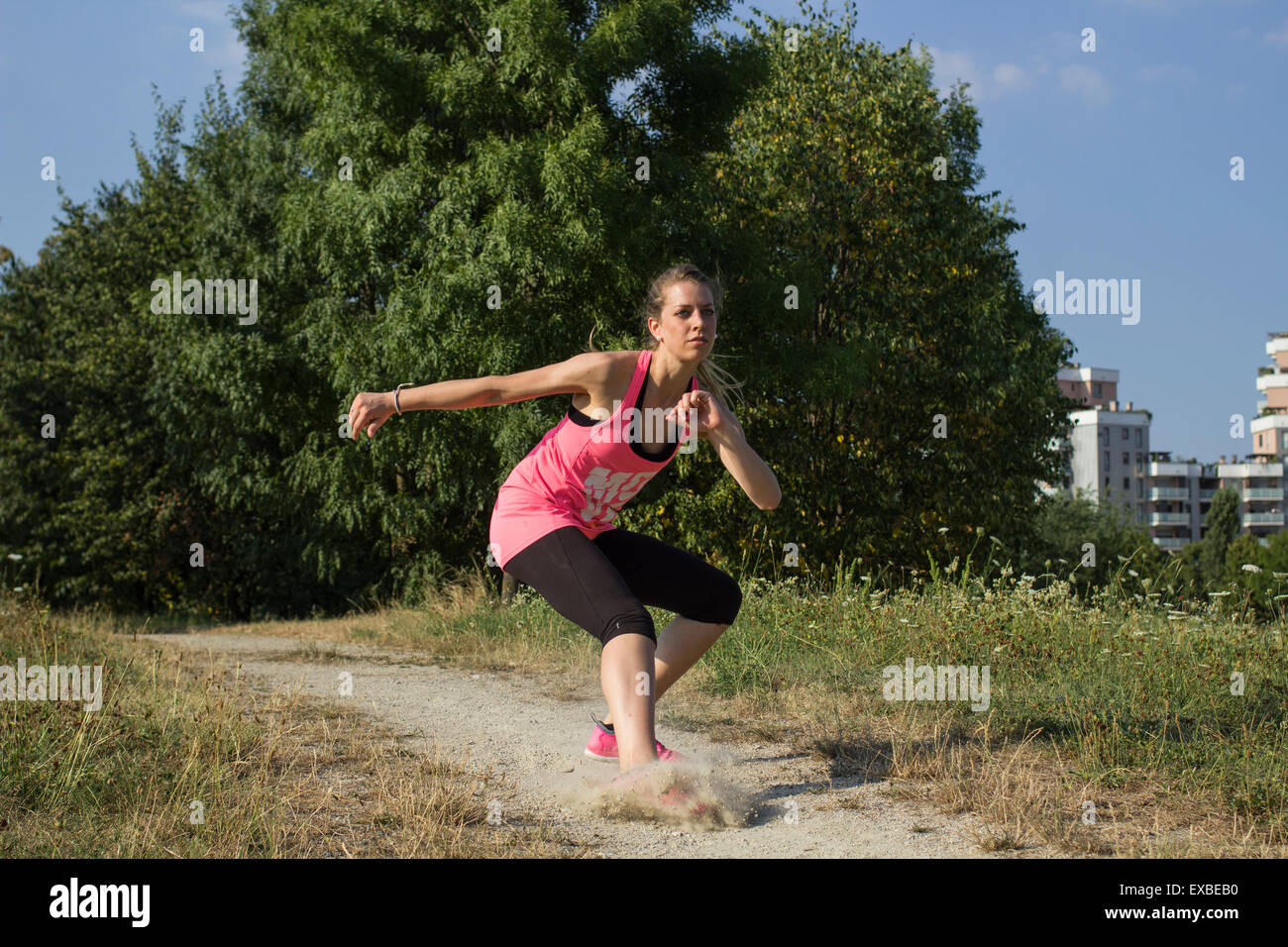 Blonde girl running at the park in the summer Stock Photo - Alamy