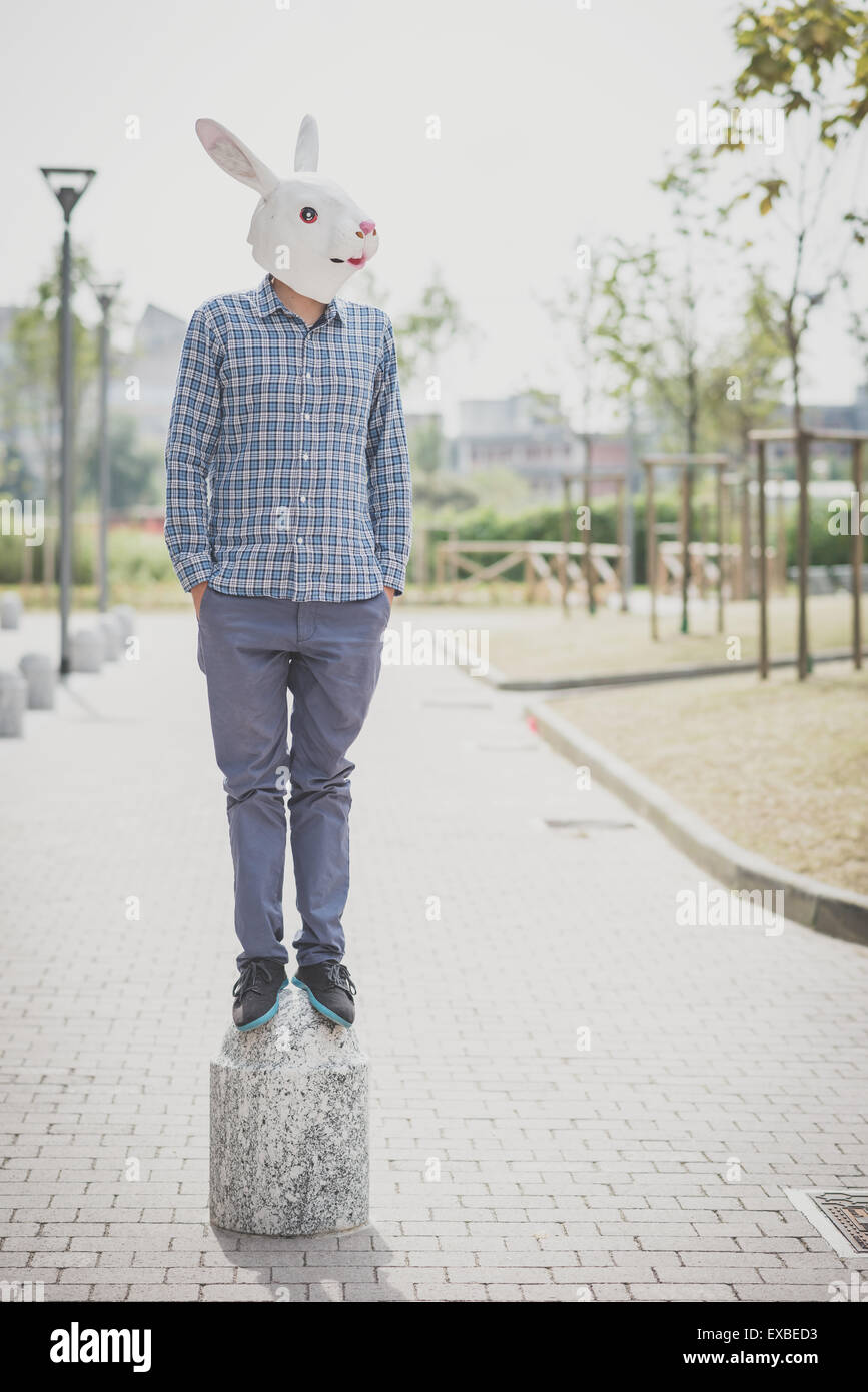 rabbit mask absurd man in the city Stock Photo - Alamy