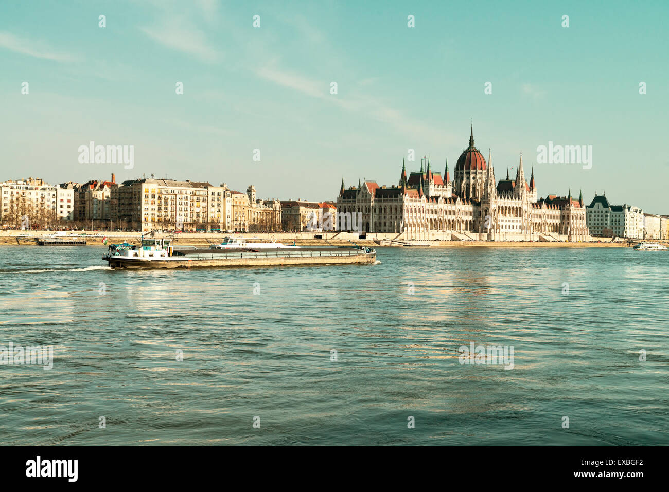 Cargo ship passes Parliament building in central Budapest on a bright ...