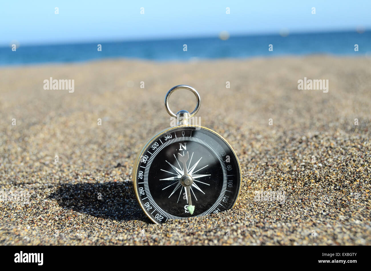 Tourist Compass in the Sand Stock Photo - Alamy
