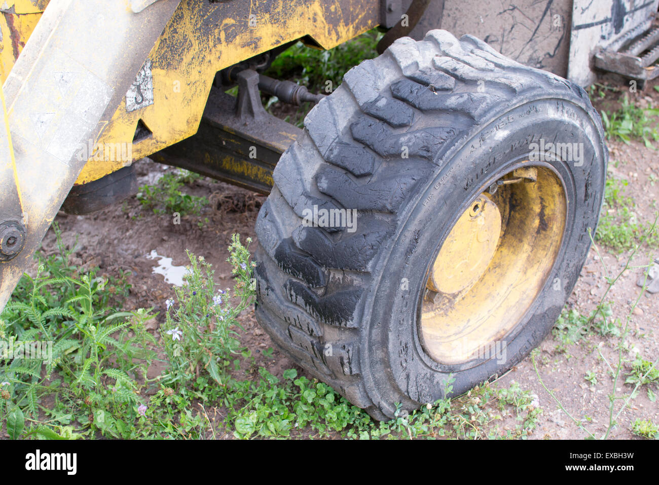 Old flat tyre of a digger that requires mending Stock Photo - Alamy