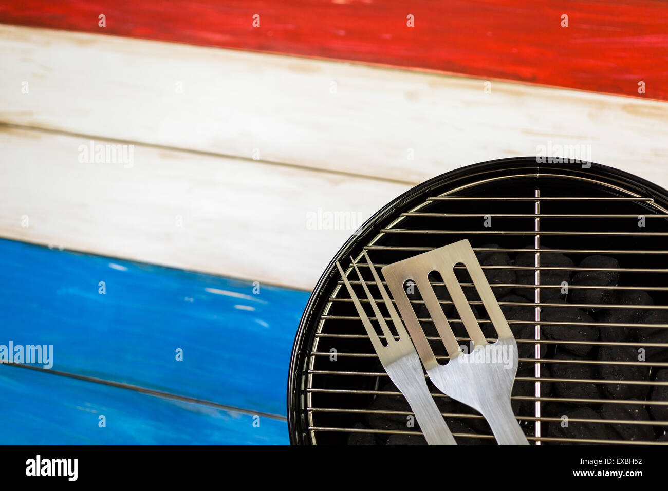 Small round charcoal grill ready for grilling at the summer picnic ...