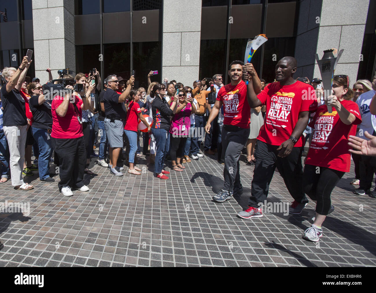 Los Angeles, California, USA. 10th July, 2015. Torch bearers carrying ...