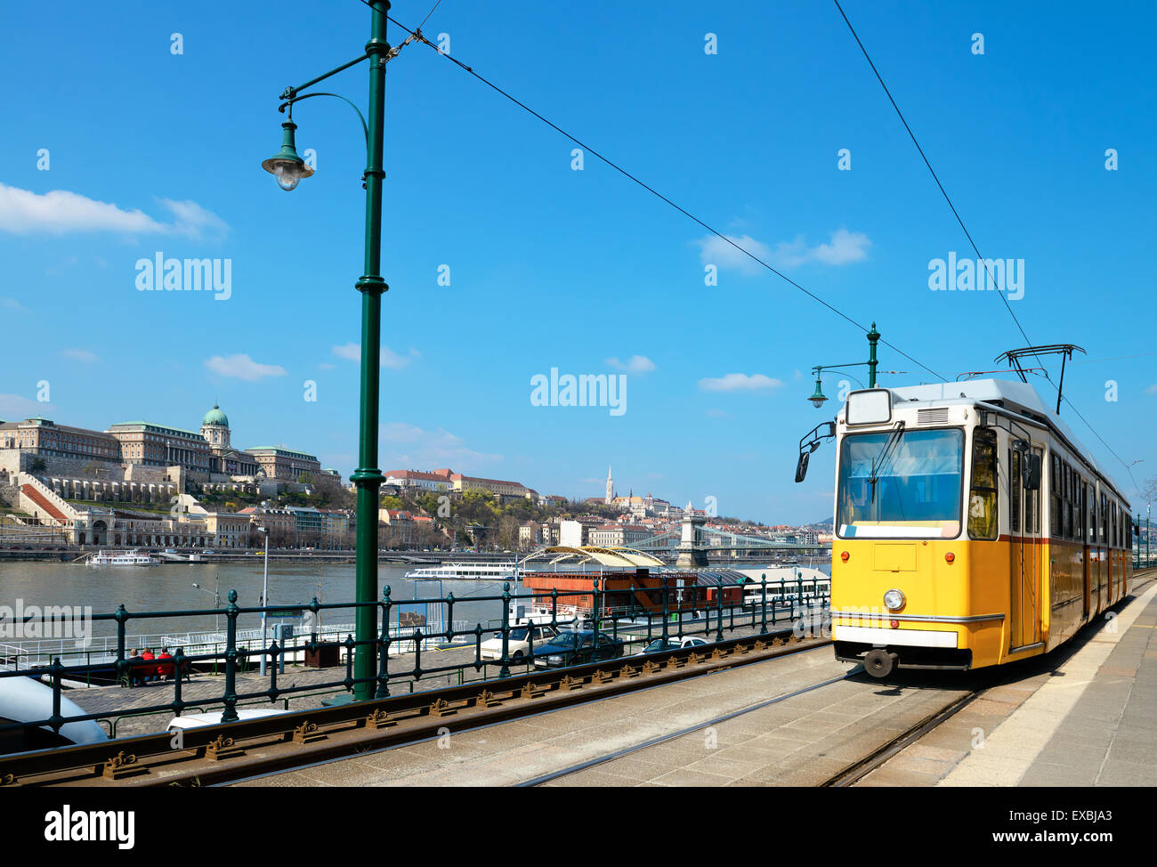Historical tram runs on the riverside in Budapest with Buda Castle as a ...
