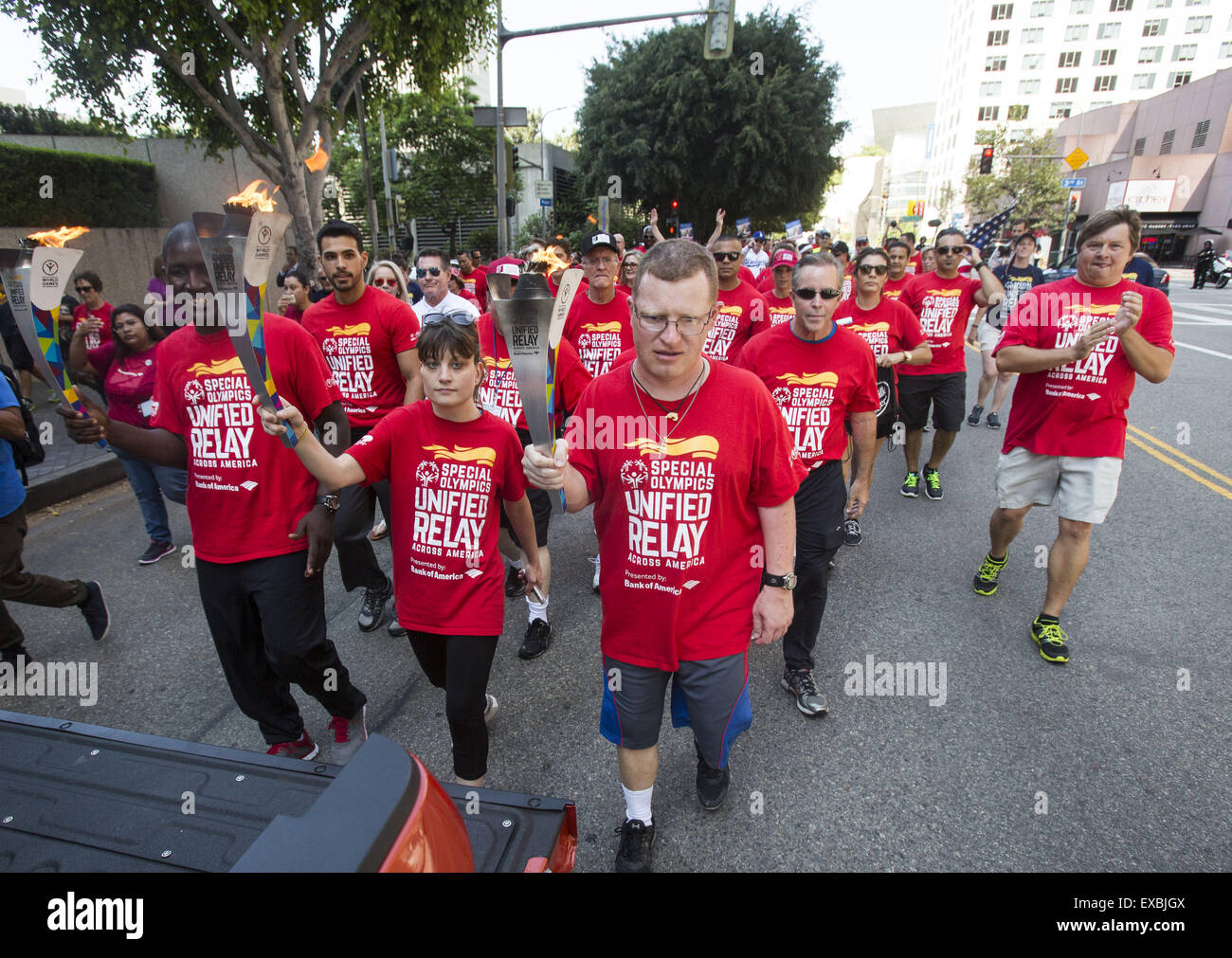 Los Angeles, California, USA. 10th July, 2015. Torch bearers carrying ...