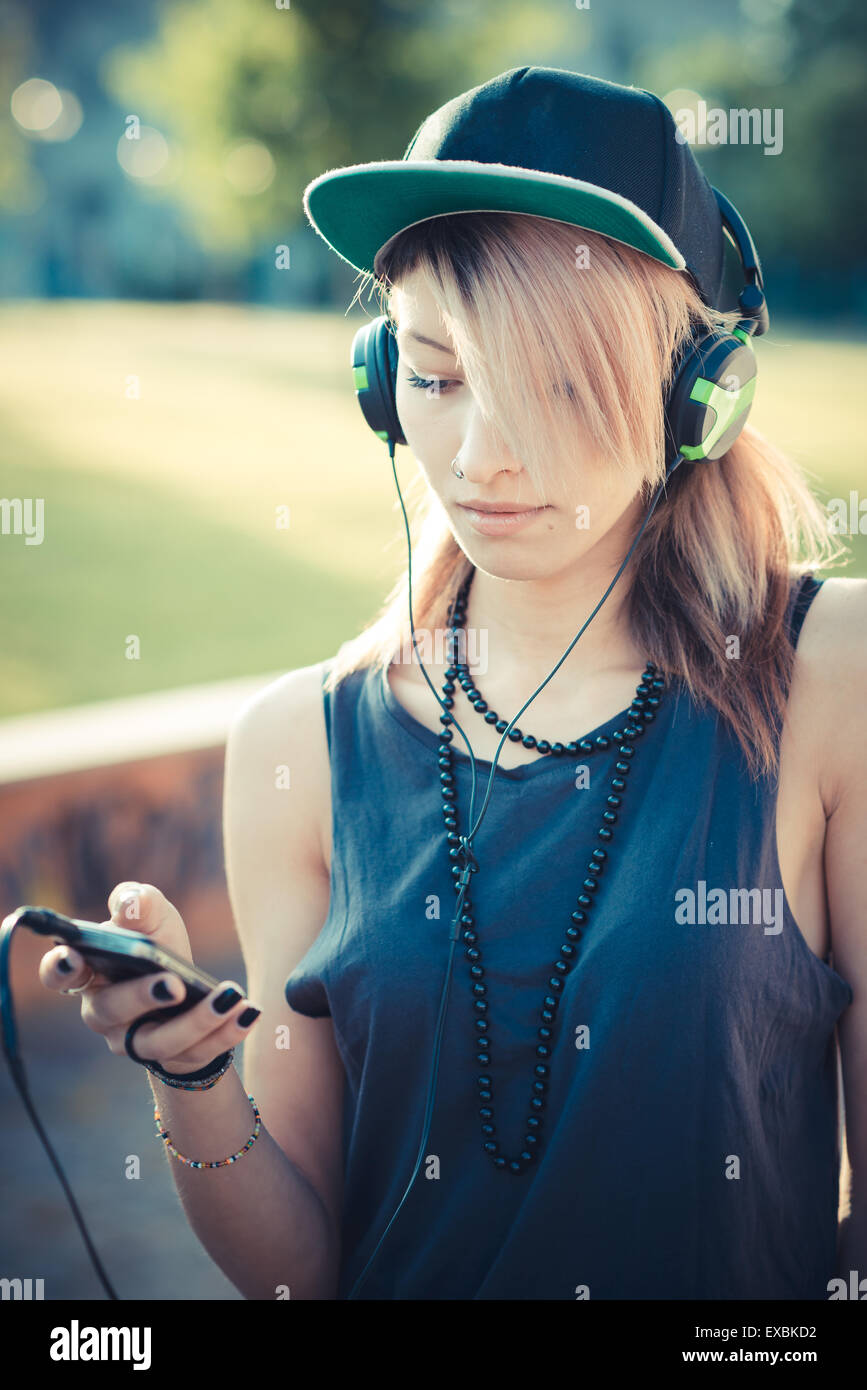 young beautiful model woman listening music in the city Stock Photo - Alamy