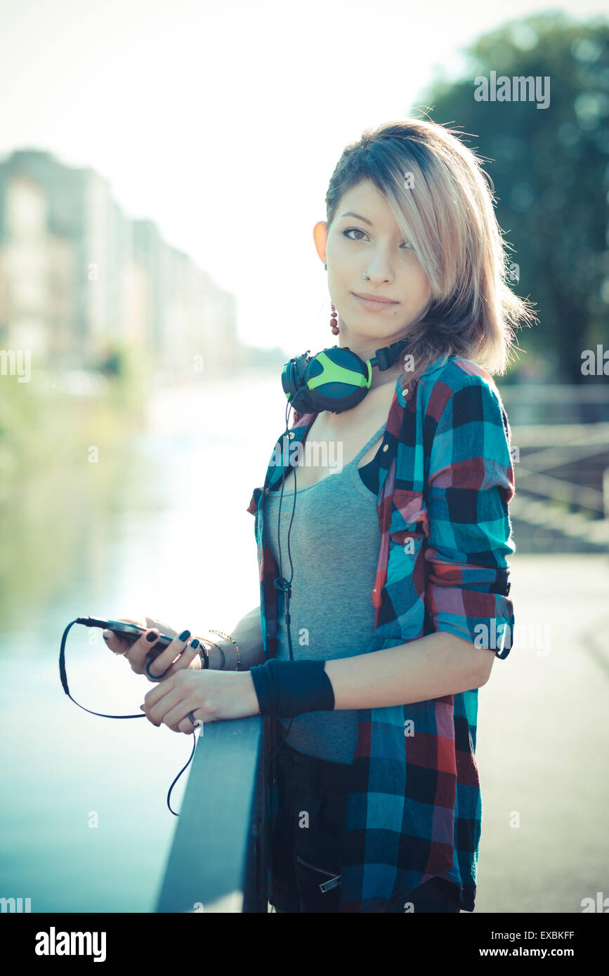 young beautiful model woman listening music in the city Stock Photo - Alamy