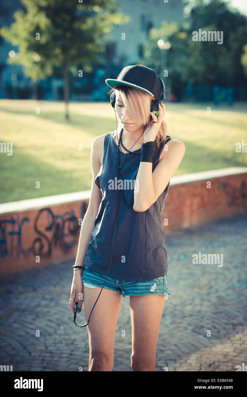 young beautiful model woman listening music in the city Stock Photo - Alamy