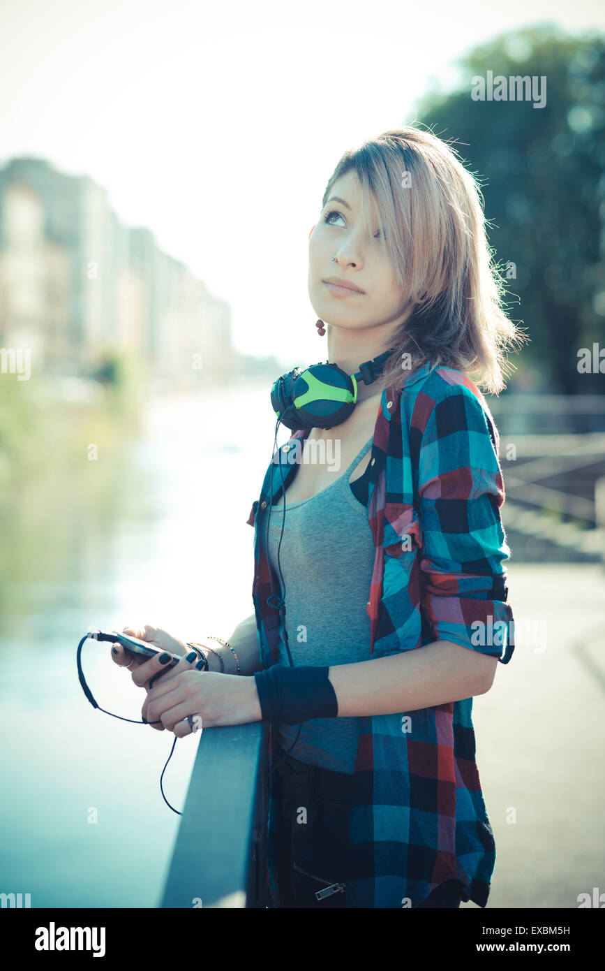 young beautiful model woman listening music in the city Stock Photo - Alamy