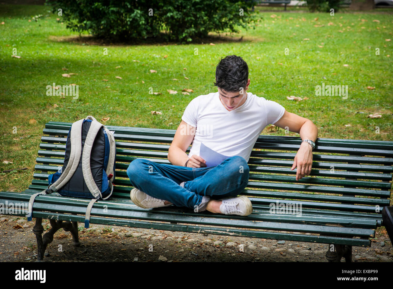 Boy sitting on wooden bench hi-res stock photography and images - Alamy