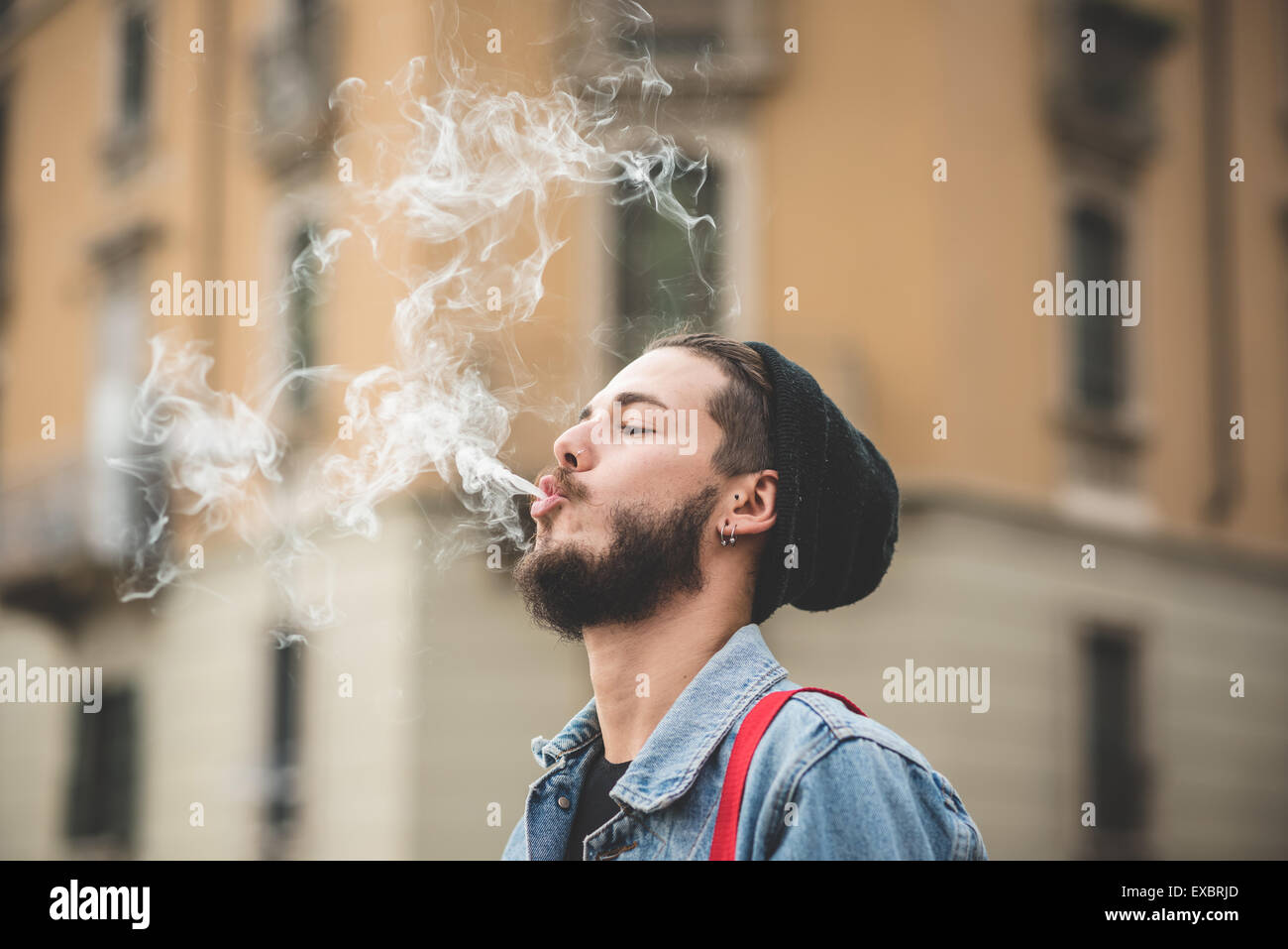 Bearded man smoking cigarette outdoor hi-res stock photography and ...