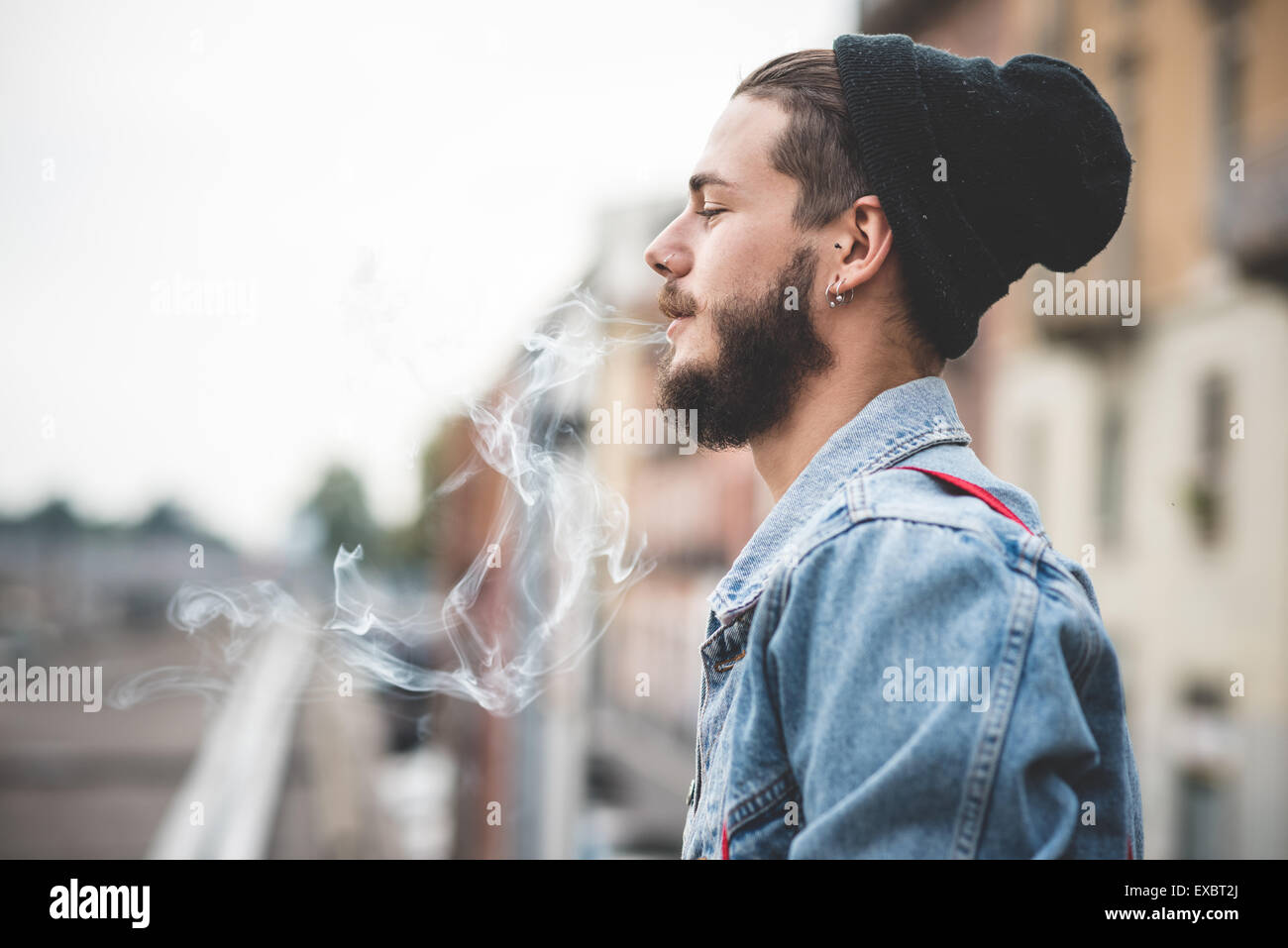 Smoking young man in the city hi-res stock photography and images - Alamy