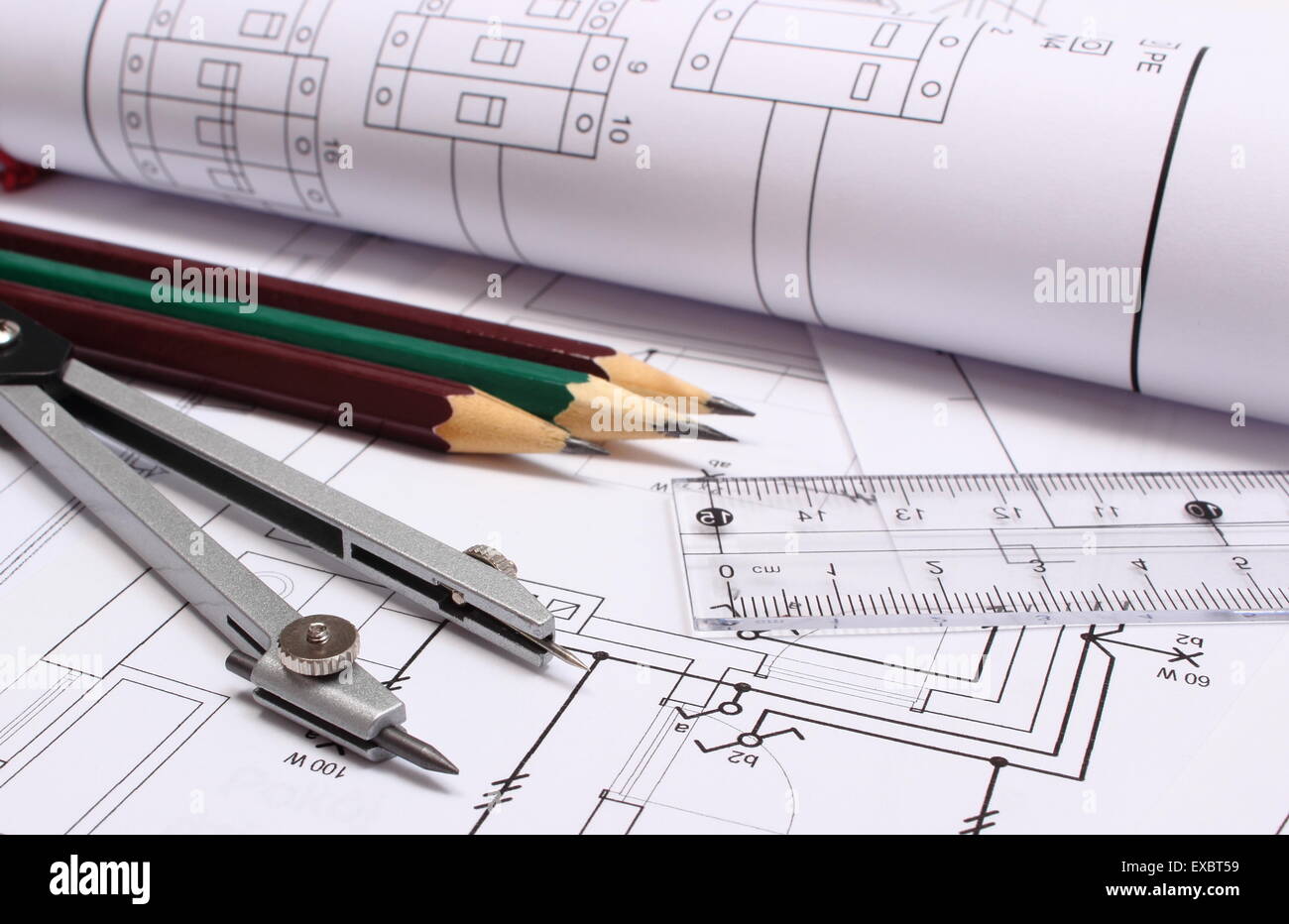 Rolls of electrical diagrams and accessories for drawing lying on ...