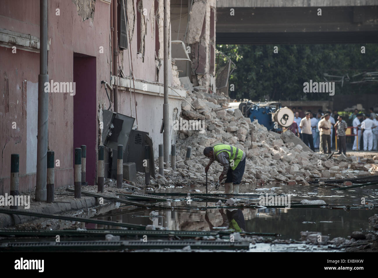 Cairo, Egypt. 11th July, 2015. A Security man checks the explosion site ...