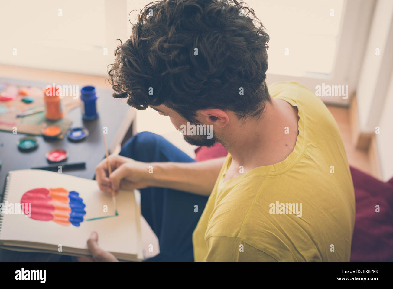 handsome hipster modern man painting at home Stock Photo - Alamy
