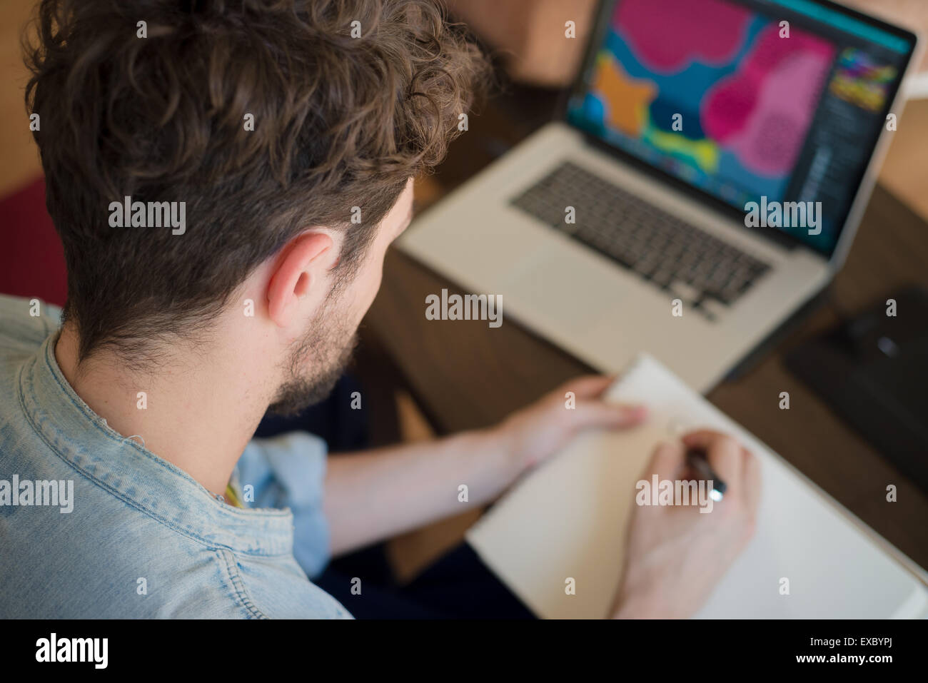 handsome hipster modern man designer working home using laptop at home ...