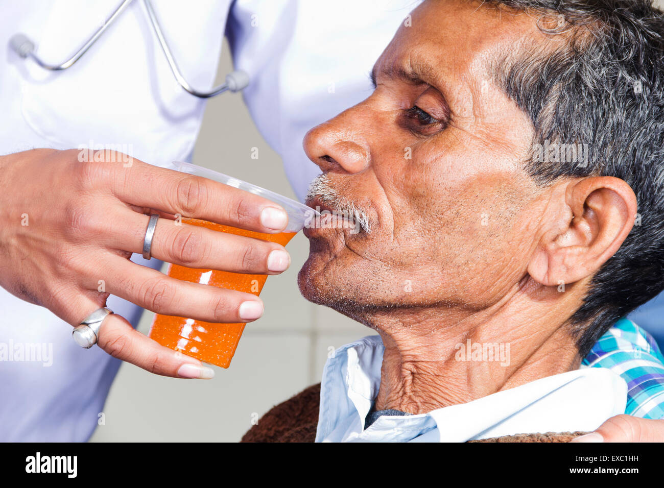 indian doctor hospital Patient feeding juice Stock Photo - Alamy