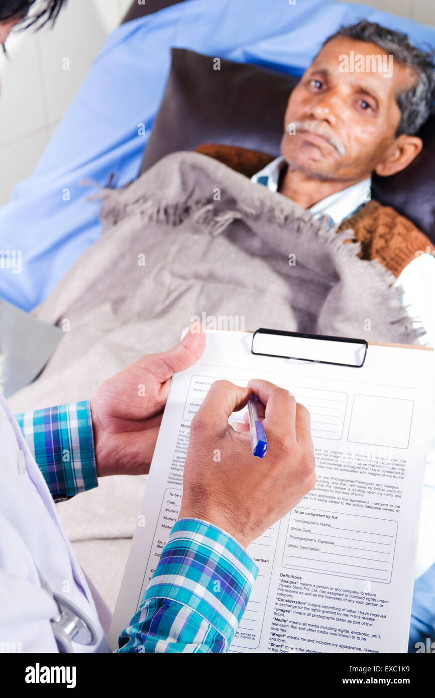 indian doctor hospital Patient writing report Stock Photo - Alamy