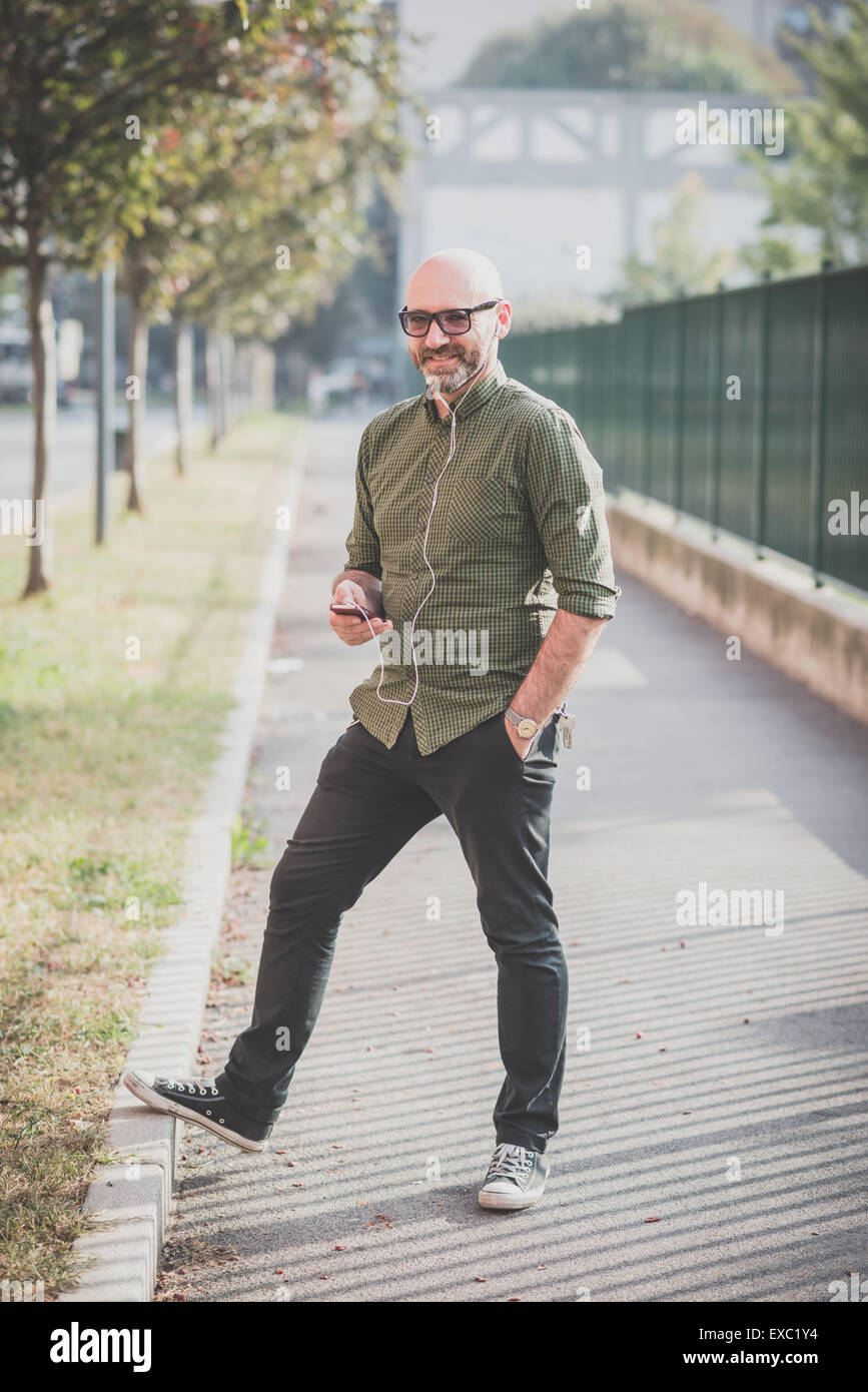handsome middle aged man listening to music in the city Stock Photo - Alamy