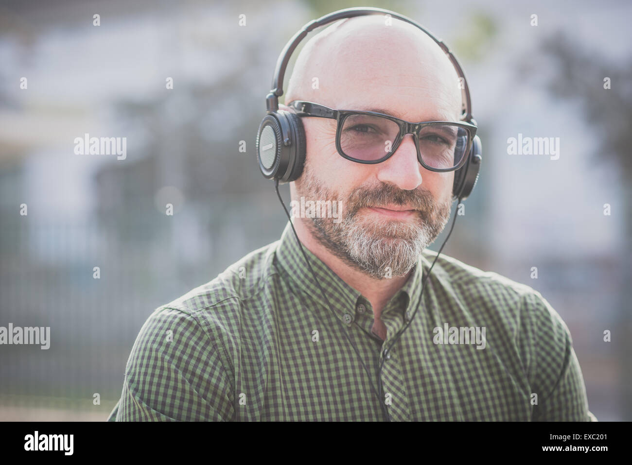 handsome middle aged man listening music in the city Stock Photo - Alamy