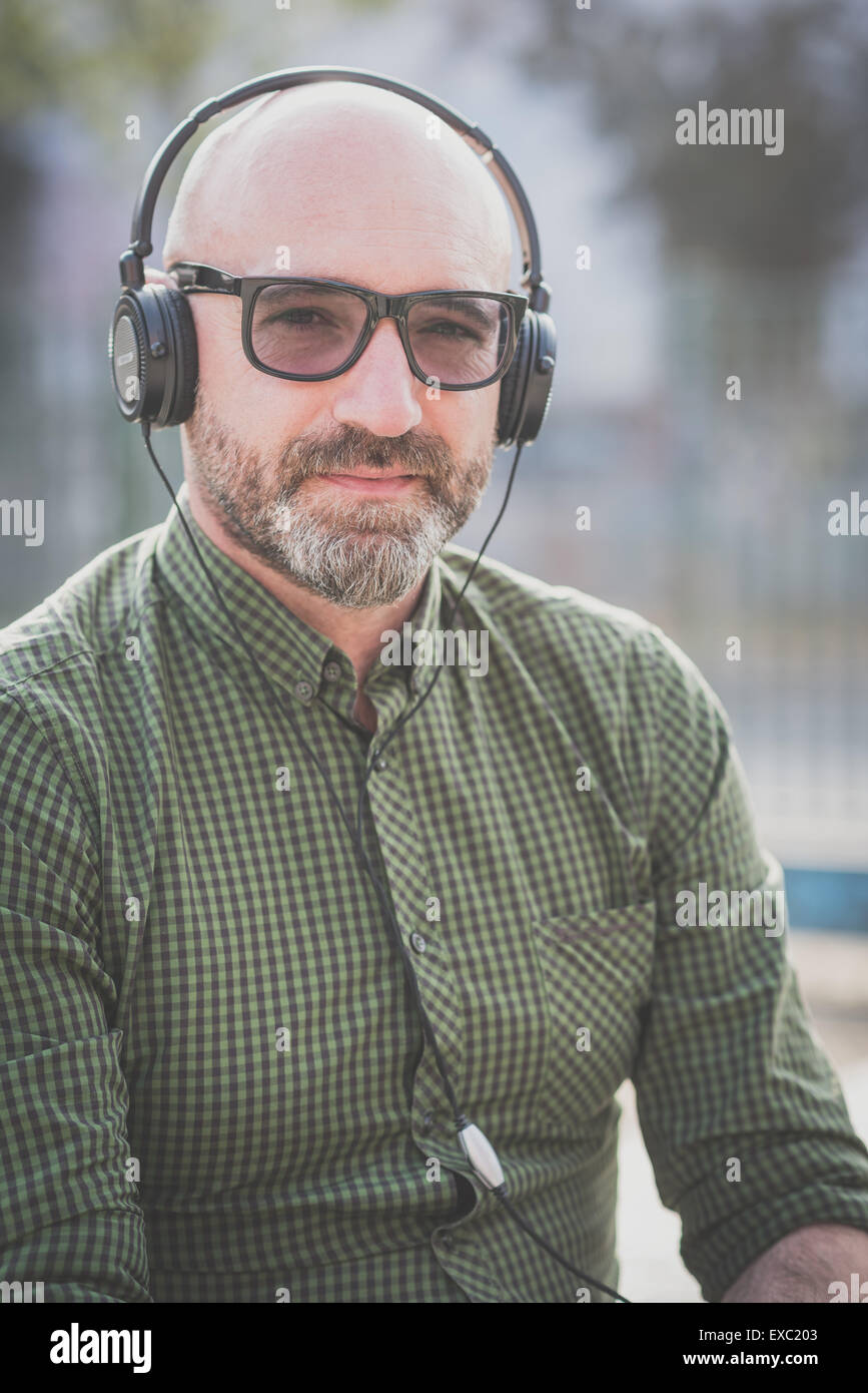 handsome middle aged man listening music in the city Stock Photo - Alamy