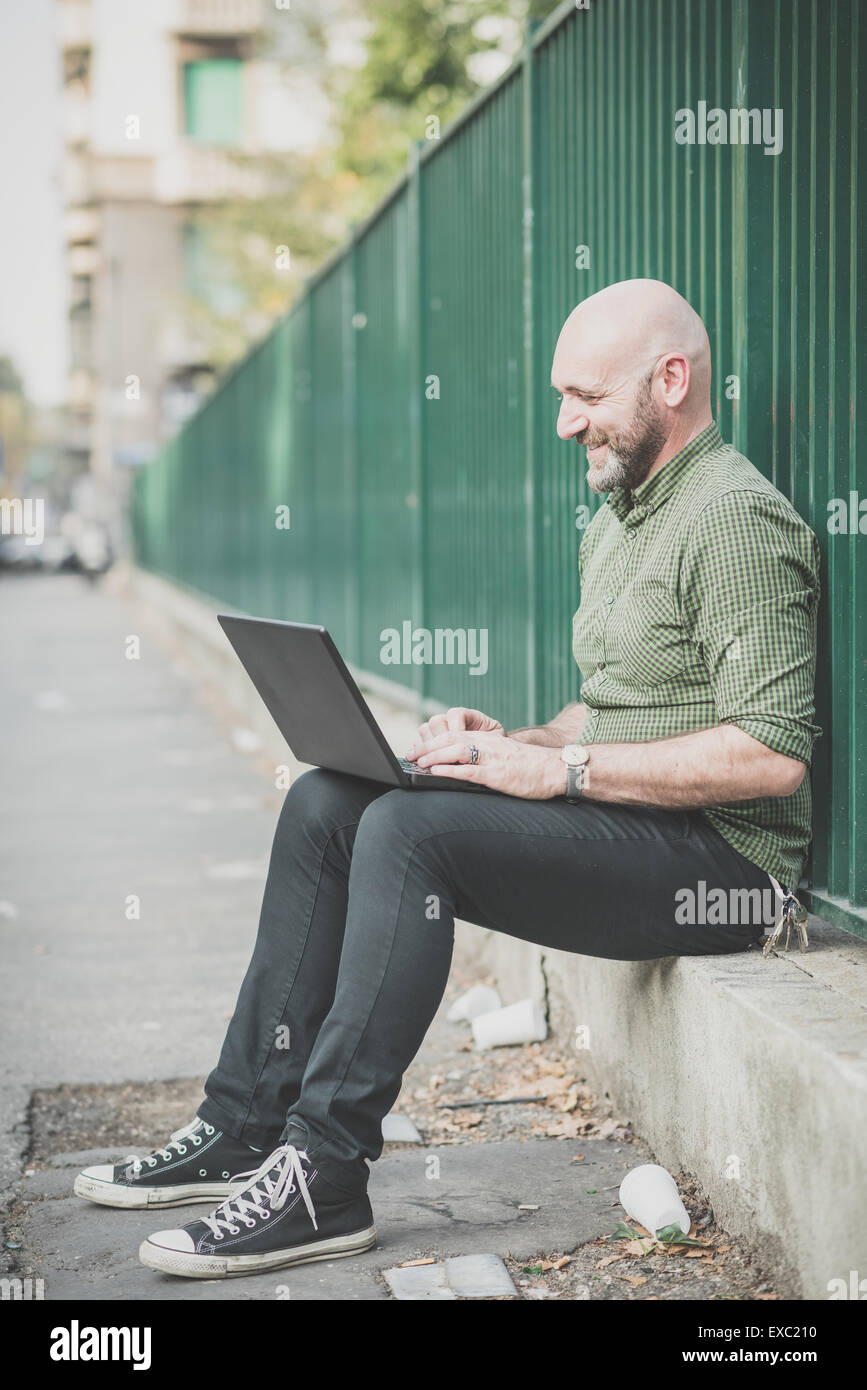 handsome middle aged man using notebook in the city Stock Photo - Alamy