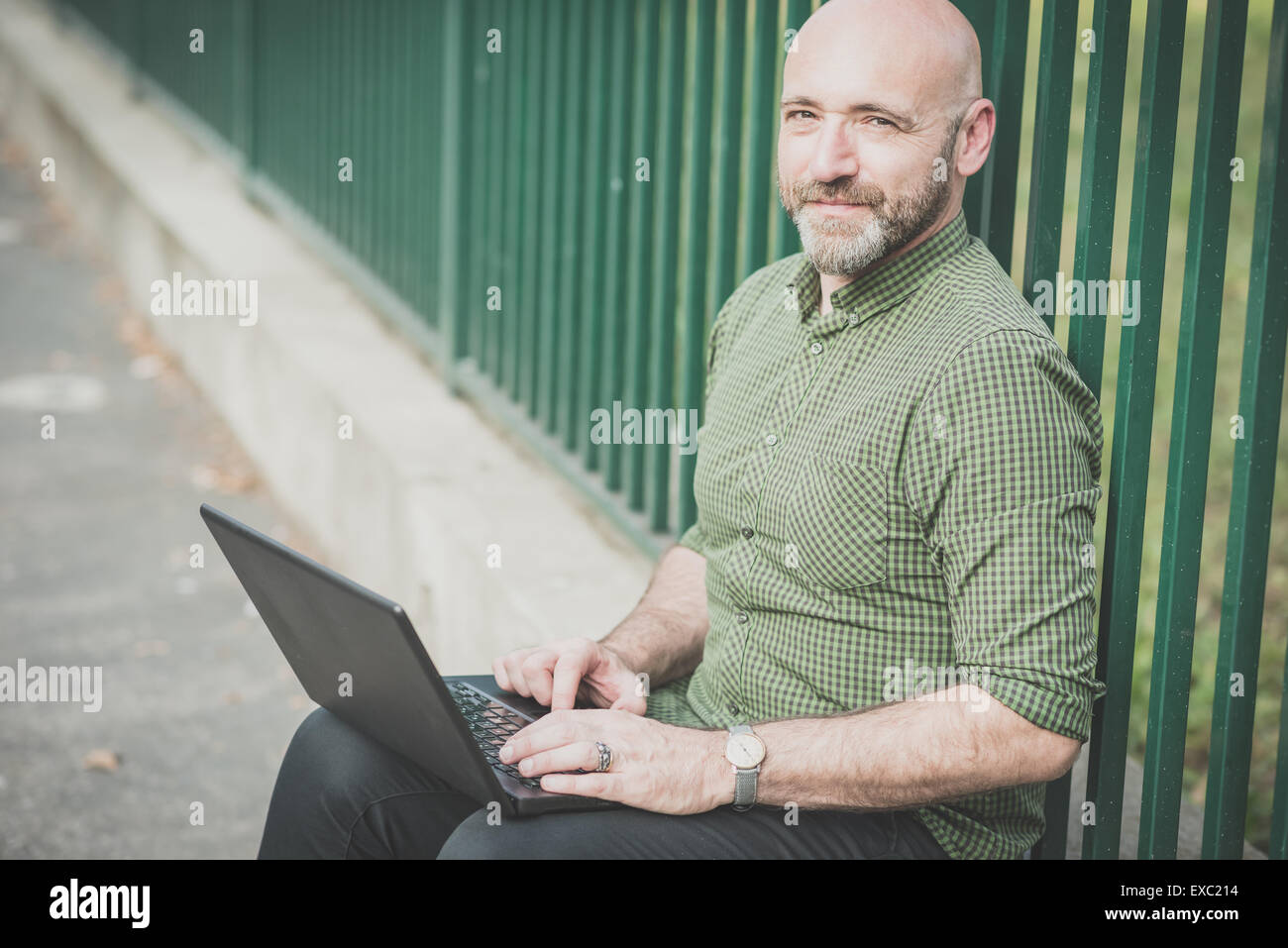 handsome middle aged man using notebook in the city Stock Photo - Alamy