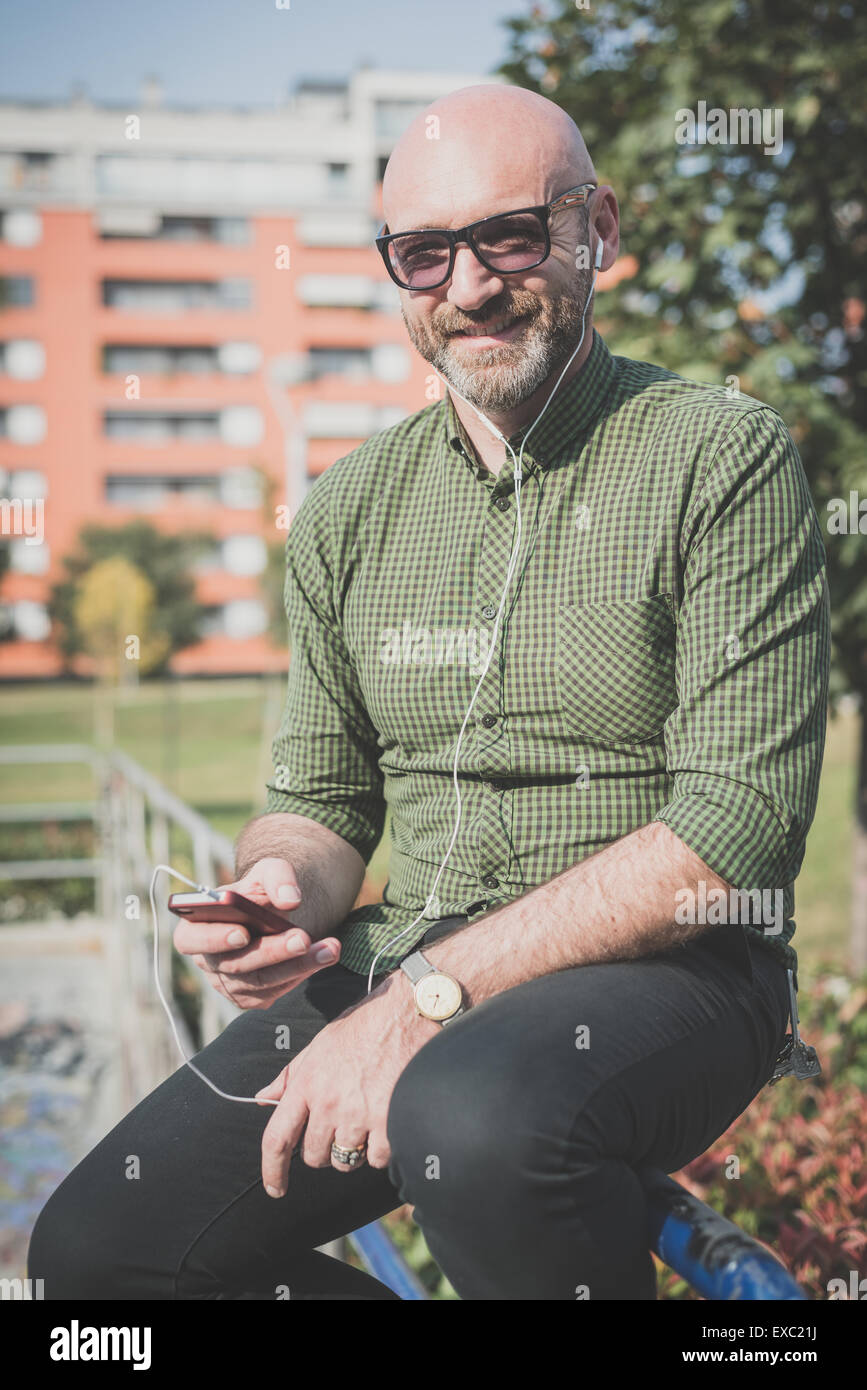 handsome middle aged man listening to music in the city Stock Photo - Alamy