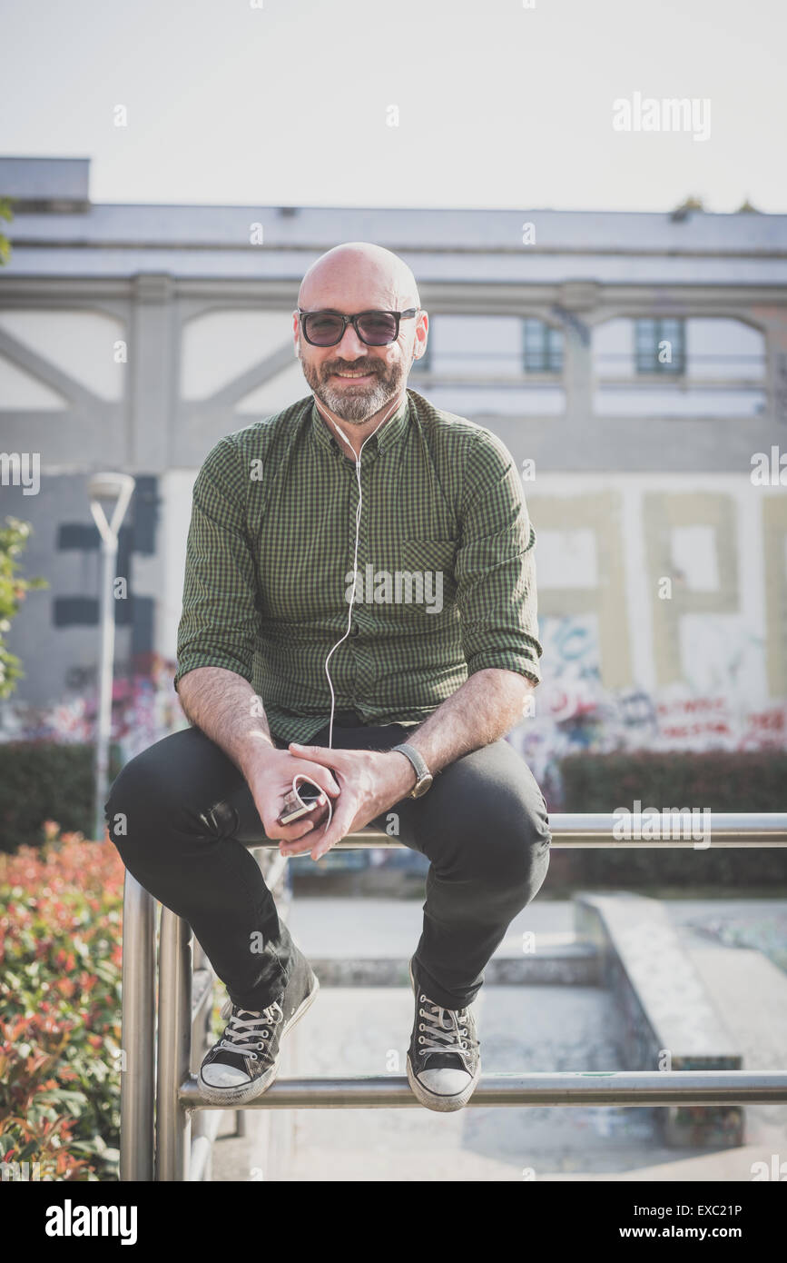 handsome middle aged man listening to music in the city Stock Photo - Alamy