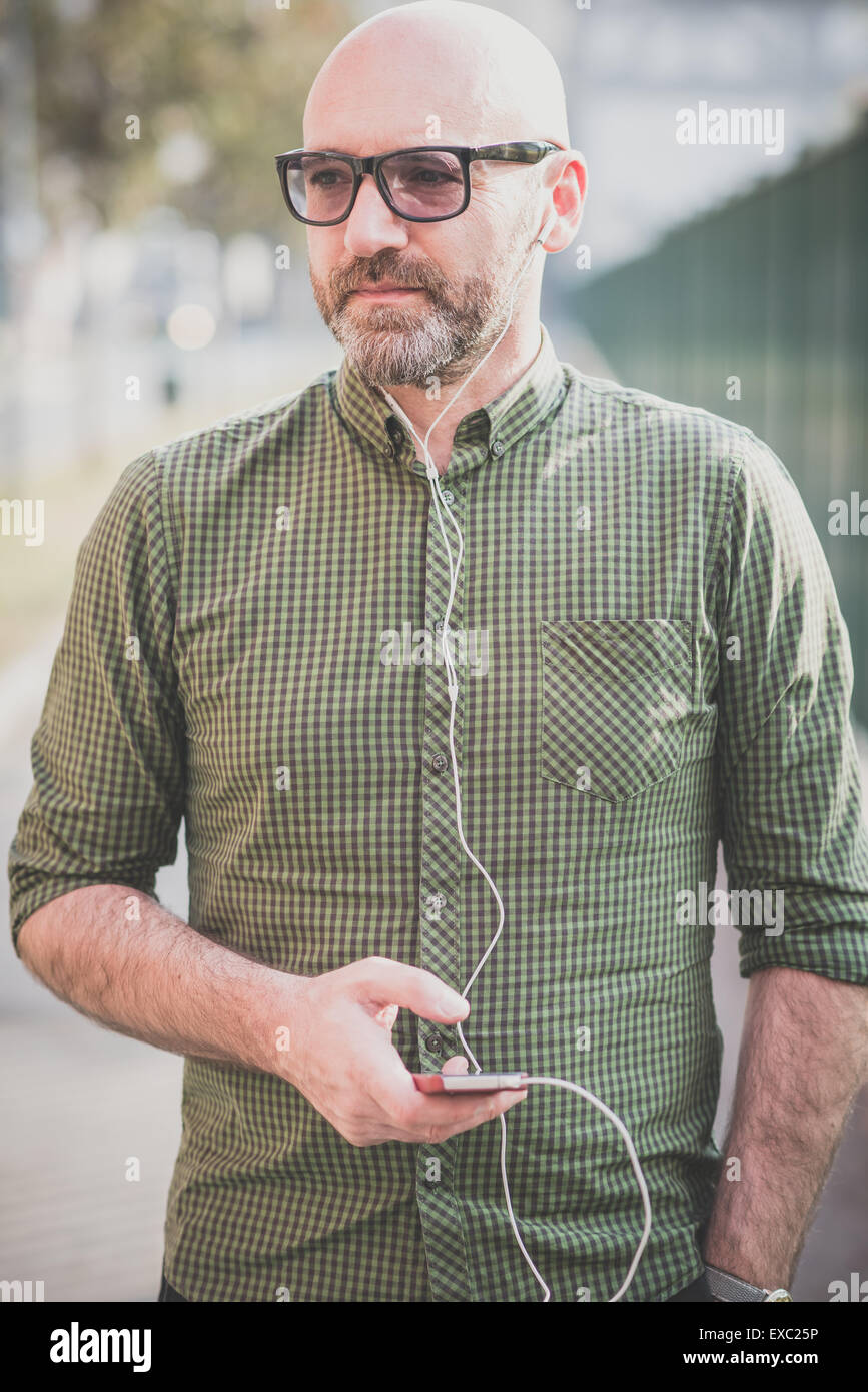 handsome middle aged man listening to music in the city Stock Photo - Alamy