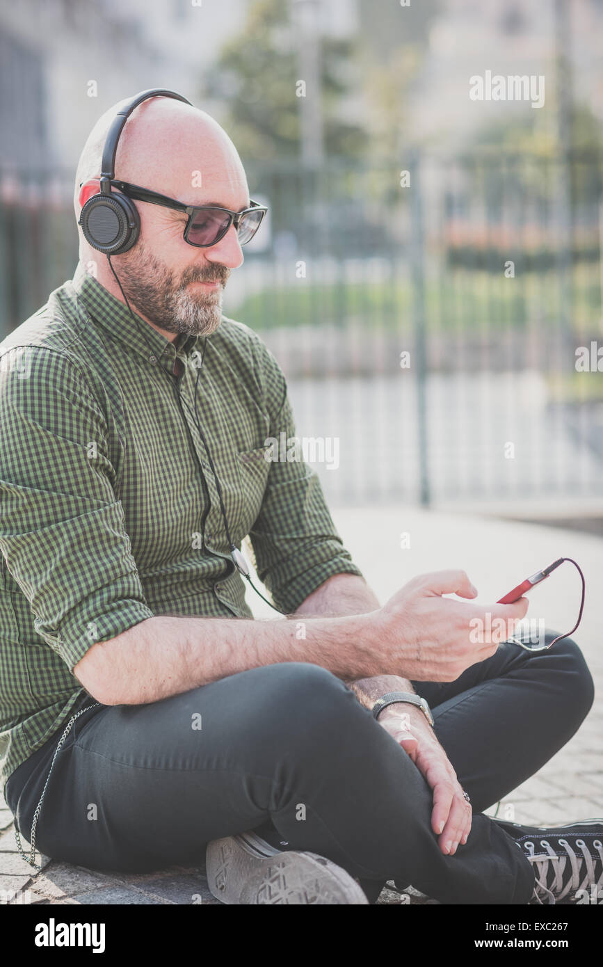 handsome middle aged man listening music in the city Stock Photo - Alamy