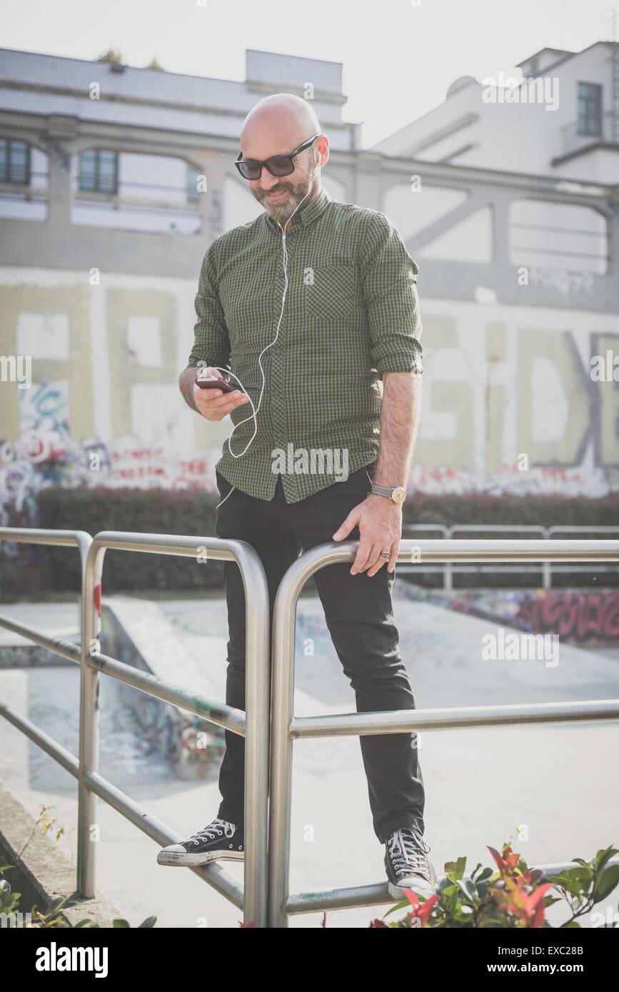 handsome middle aged man listening to music in the city Stock Photo - Alamy