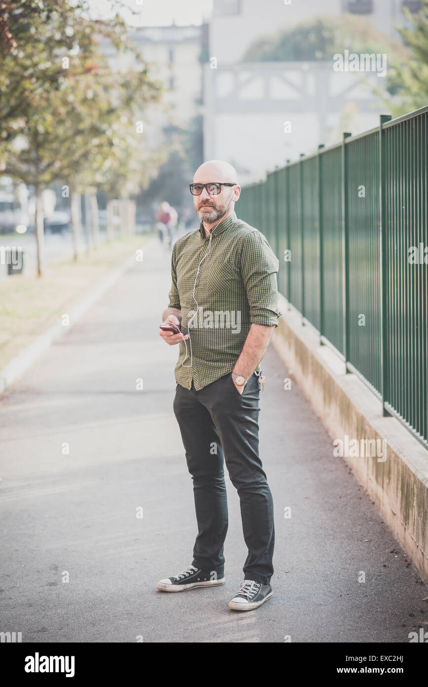 handsome middle aged man listening to music in the city Stock Photo - Alamy
