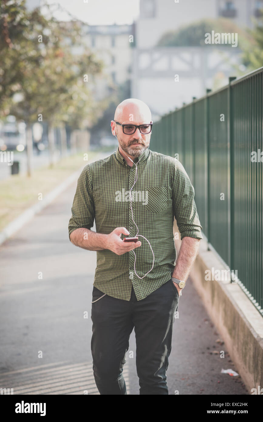 handsome middle aged man listening to music in the city Stock Photo - Alamy
