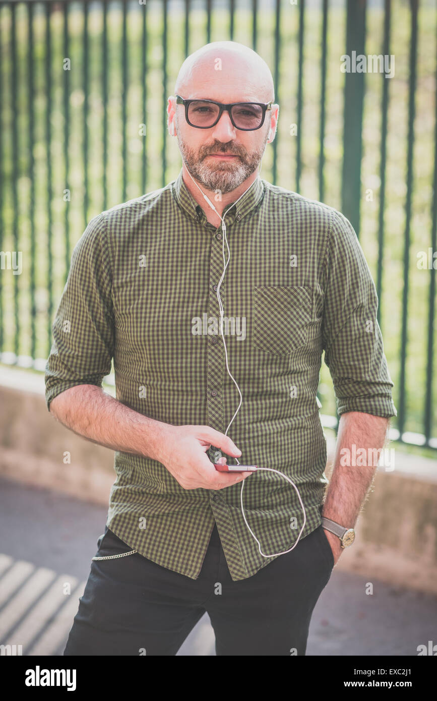 handsome middle aged man listening to music in the city Stock Photo - Alamy