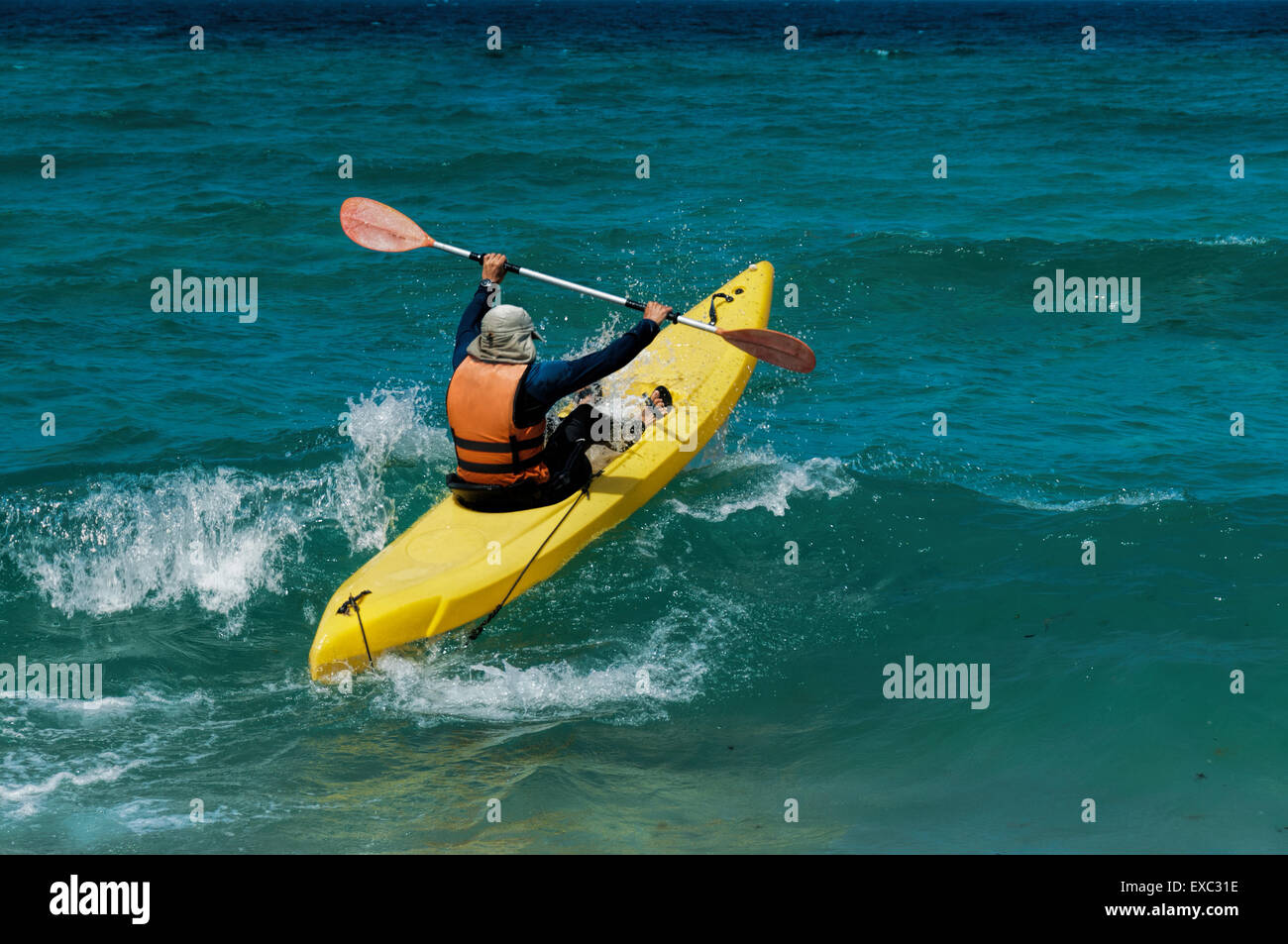 athlete compete in the kayak with sea waves trying to swim away from ...
