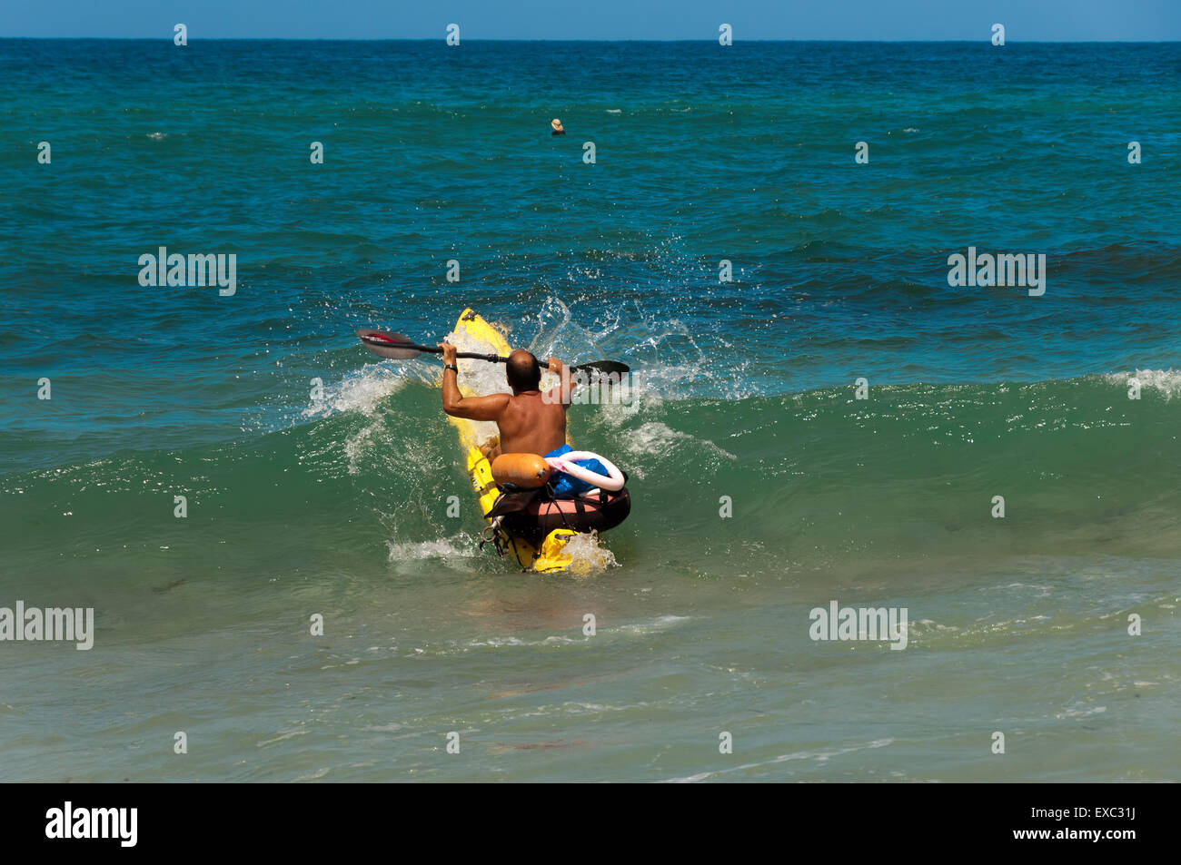 Lifeguard floats in a canoe to rescue a drowning man Stock Photo - Alamy