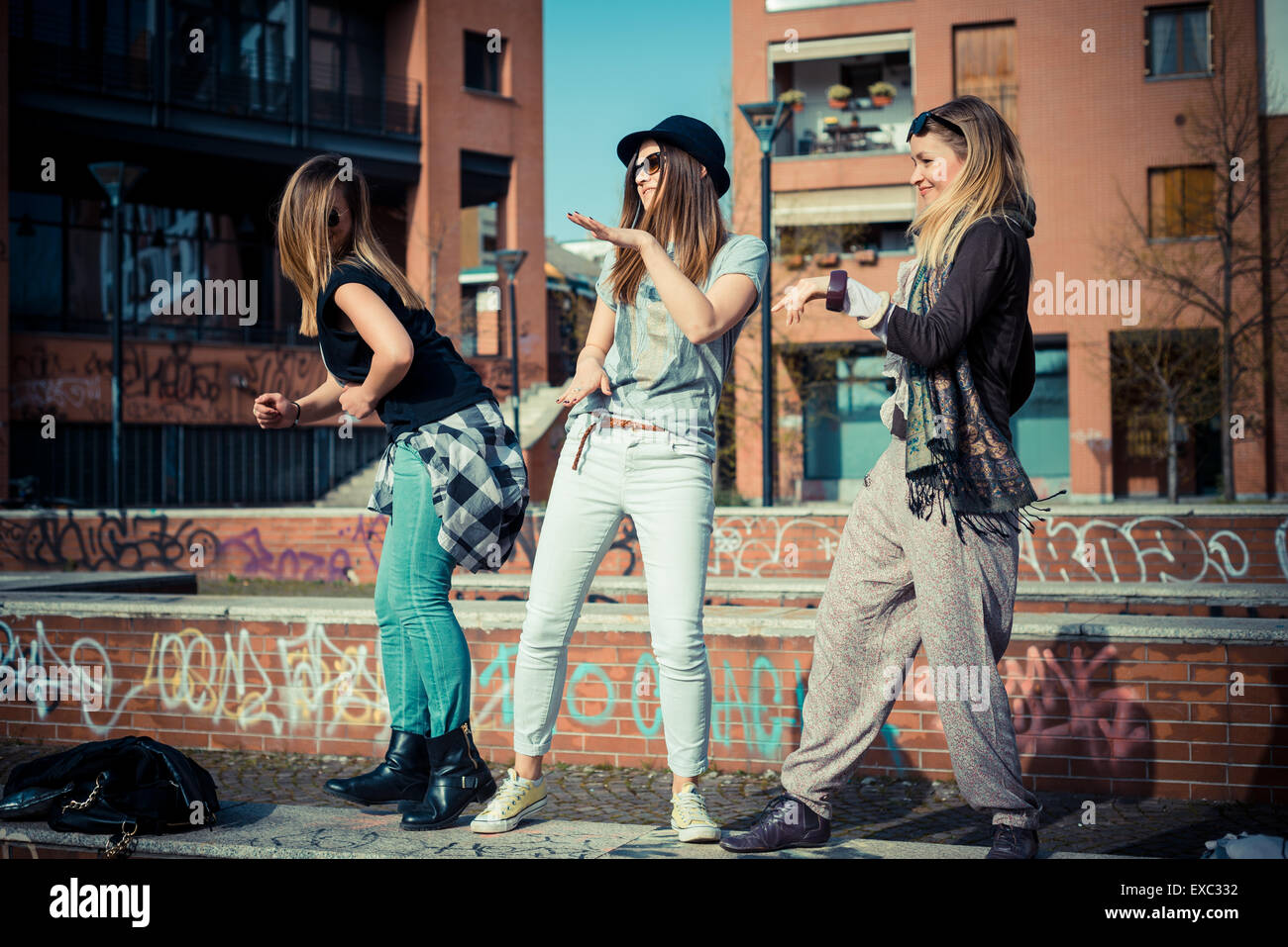 three beautiful friends authentic in urban contest dancing Stock Photo ...