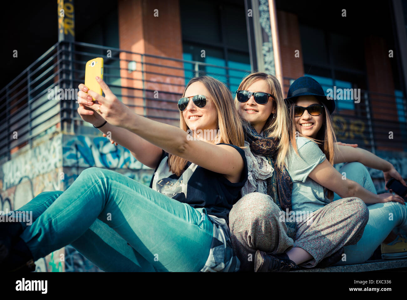 three beautiful friends authentic in urban contest Stock Photo - Alamy