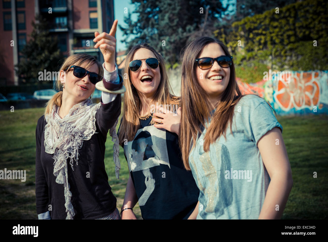 three beautiful friends authentic in urban contest Stock Photo - Alamy