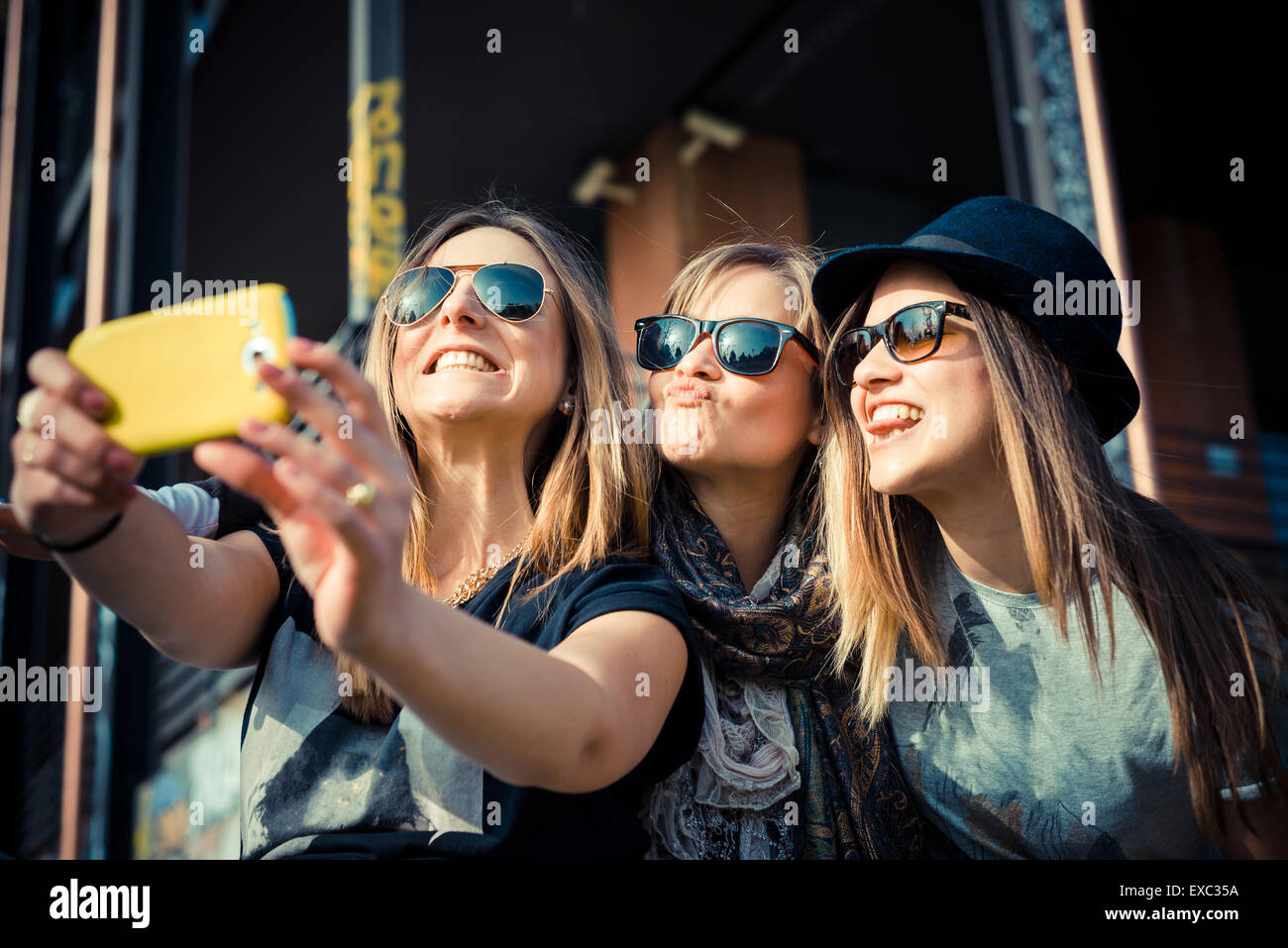 three beautiful friends authentic in urban contest Stock Photo - Alamy