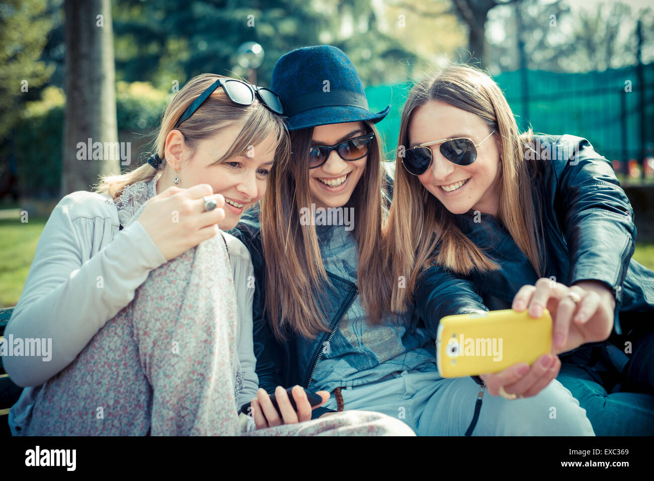 three beautiful friends authentic in urban contest Stock Photo - Alamy