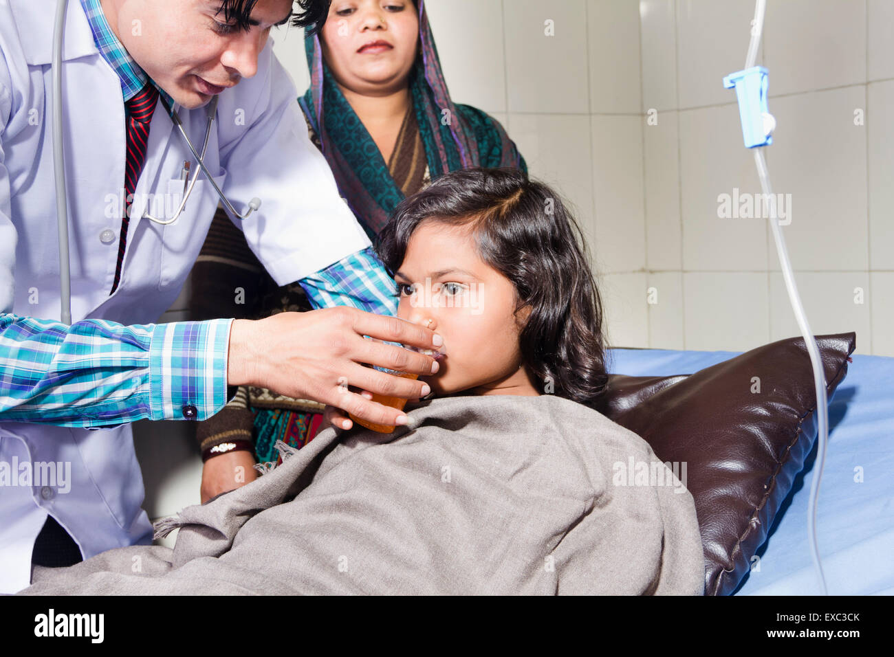 indian doctor hospital Patient Feeding juice Stock Photo - Alamy