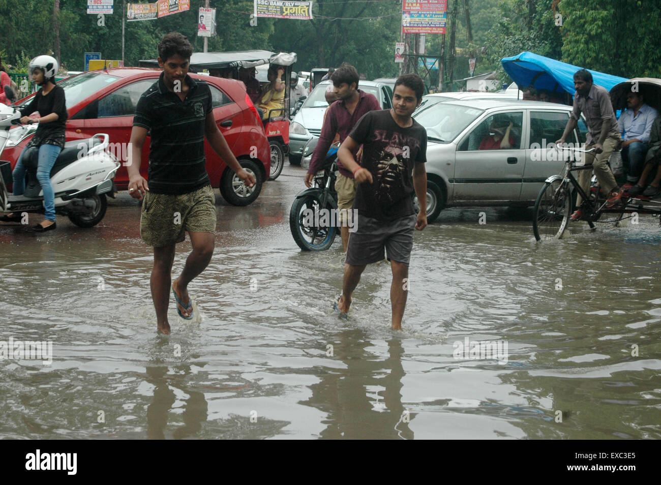 Allahabad, India. 12th July, 2015. The rain water clogged the road ...