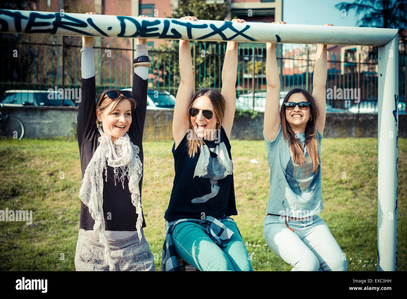three beautiful friends authentic in urban contest Stock Photo - Alamy